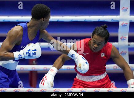 United States' Omari Jones, left, fights with Japan's Sewonrets Okazawa ...