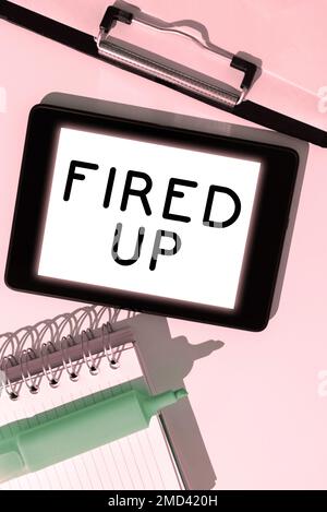 Hand writing sign Fired Up. Business idea means that someone energized ...