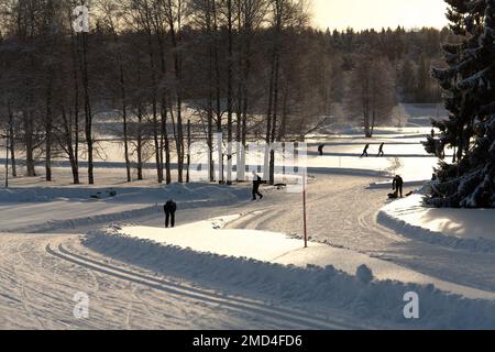 UMEÅ, SWEDEN ON JANUARY 21, 2023. Unidentified people enjoying weather ...