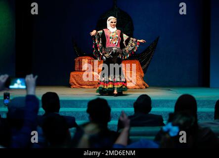 A model wearing a traditional Iraqi folk costume dances in the annual ...