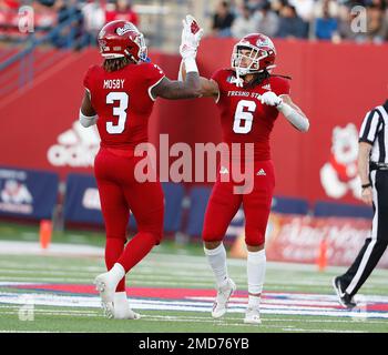 Fresno State linebacker Levelle Bailey, right, high fives defensive end ...
