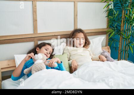 Adorable hispanic boy waking up stretching arms at bedroom Stock Photo ...