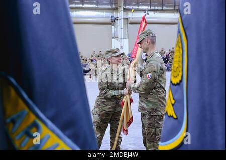 Brig. Gen. Christine A. Beeler passes the colors to Col. Justin L. Dearmond, charging the new ...
