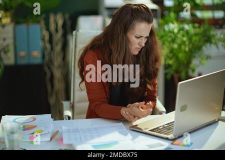 unhappy modern small business owner woman working with documents in the ...
