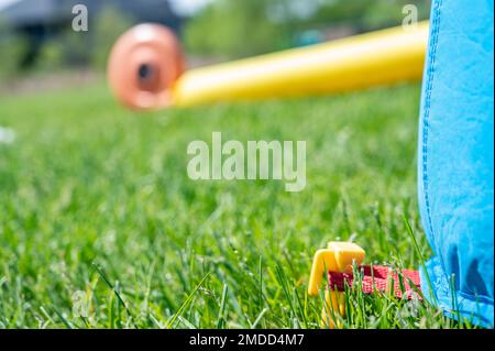 Bouncy house stake pinned into turf Stock Photo - Alamy