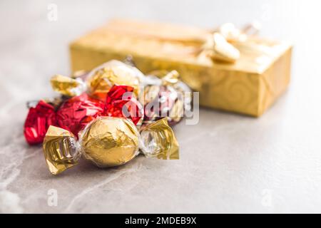 Sweet candy wrapped in foil on the kitchen table Stock Photo - Alamy