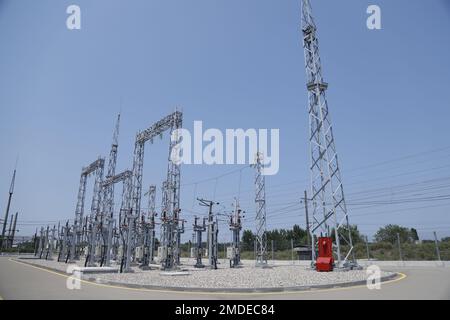 An aerial view of electrical substation surrounded by metal towers ...