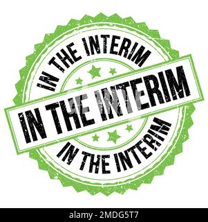 IN THE INTERIM text written on blue zig-zag stamp sign Stock Photo - Alamy