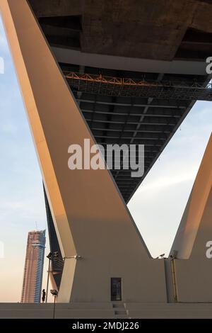 A female walks past the large two-column bent suspension bridge over ...