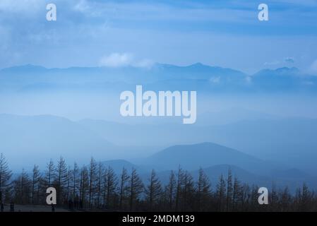 Japan mountain range in hazy blue sunshine Stock Photo - Alamy