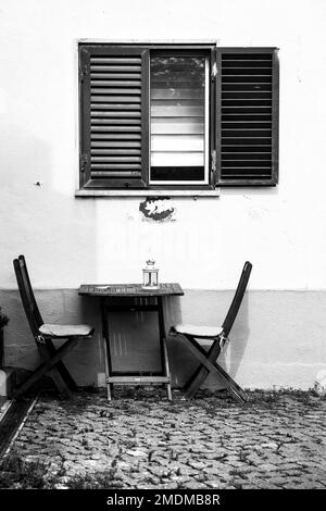 Typical Portuguese facade with black wooden window and curtain on ...