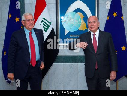 Iraqi Foreign Minister Fouad Hussein, right, shakes hands with his ...