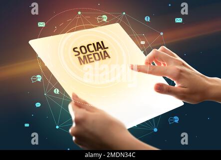 holding futuristic tablet, social media concept Stock Photo - Alamy