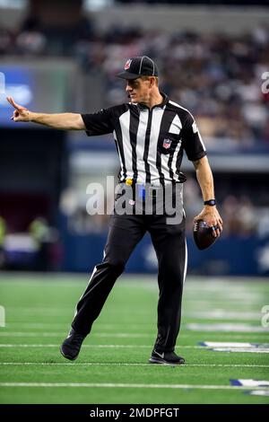 NFL umpire Alan Eck (76) carries the football down the field during an ...