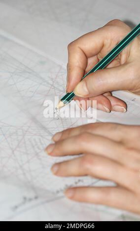 The woman hands tracing the sewing drawing Stock Photo - Alamy