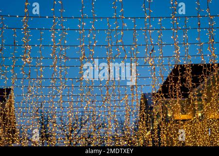 Festive hanging LED garlands against the background of the night sky ...