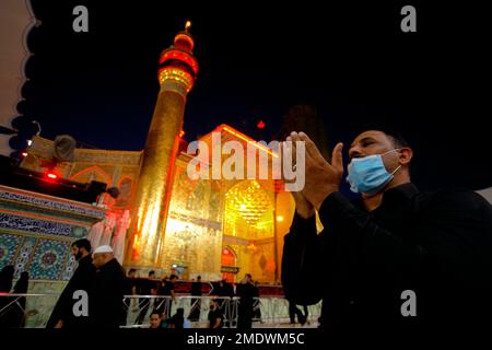 Shiite faithful pilgrims pray inside the holy shrine of Imam Ali, the ...