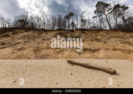 Looking up to high sandy and stony cliff next to the beach Stock Photo ...