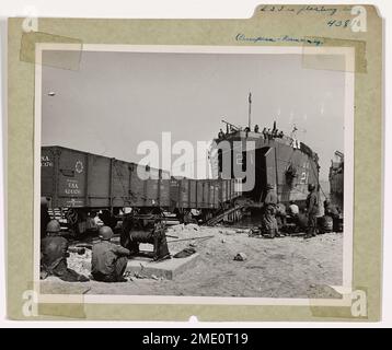 Coast Guard-manned LST Serves as Floating Rail Link. A rail bridge ...