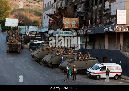 Lebanese army soldiers sit on their armored vehicle with a 106mm ...