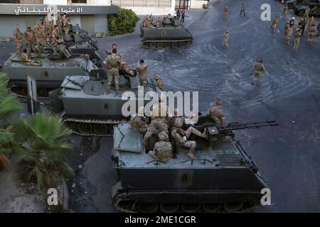 Lebanese army soldiers sit on their armored vehicle with a 106mm ...