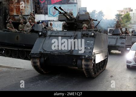 Lebanese army soldiers sit on their armored vehicle with a 106mm ...
