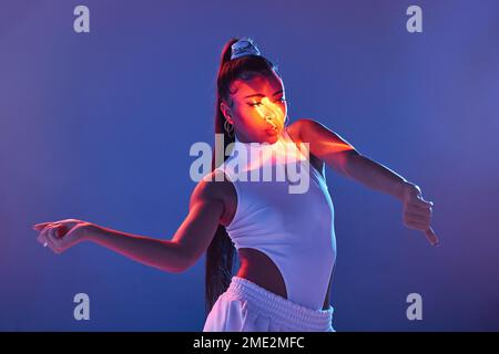 Young talented female dancer with long straight ponytail in white ...