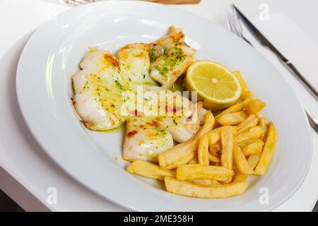 Grilled cuttlefish with fries and green sauce Stock Photo - Alamy