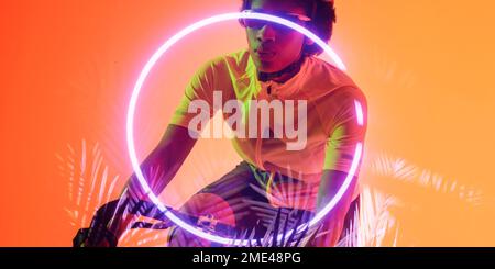 African american female athlete wearing eyewear and helmet riding bike ...