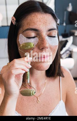 Face massage roller on color background Stock Photo - Alamy