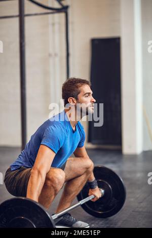 young handsome man works out in modern gym Stock Photo - Alamy