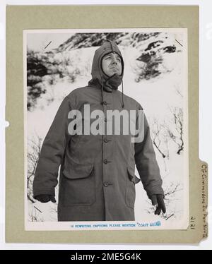 Coast Guard Commodore Earl G. Rose stands with a team of huskies ...