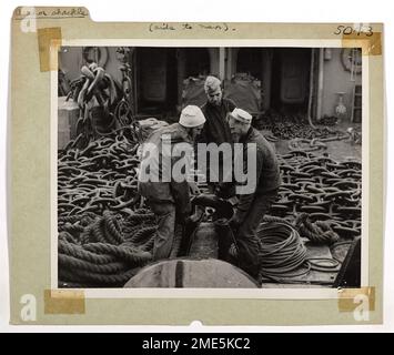 Coast Guardsmen aboard the Buoy Tender LAUREL rig a wire hawser to lift ...
