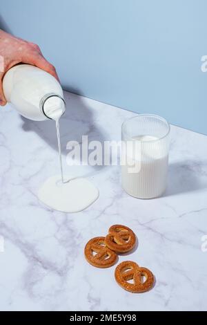 a man's hand pours milk from a bottle. artphotography Stock Photo - Alamy