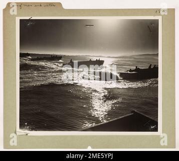 Coast Guard-manned landing barges and amphibious tractors, known as ...