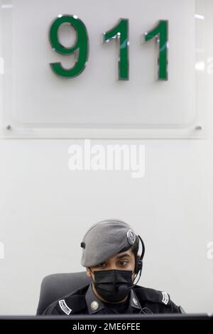 A Saudi policeman receives calls at the National Center for Security ...
