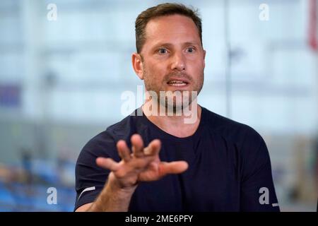 Simone Biles of the U.S. talks to her coach Laurent Landi at the uneven ...