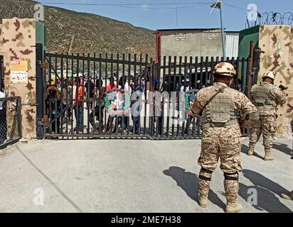 Dominican Republic soldiers stand guard as Haitians wait to cross the ...