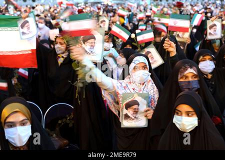 Supporters of the Iranian president elect Ebrahim Raisi attend a ...