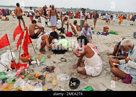 Priests perform exorcism on a Hindu devotees on the bank of Sangam, the ...