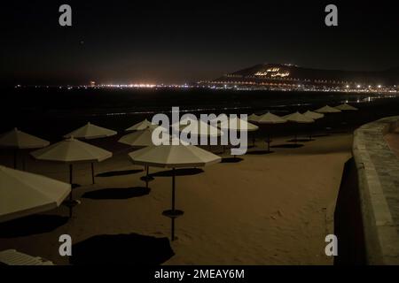 Agadir, Morocco beach with Moroccan motto on the mountain. Writing on ...