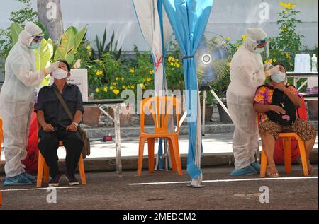 Health workers collect nasal swabs from locals for coronavirus testing ...