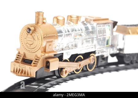 toy train with freight car trolley on railway tracks, isolated on white ...