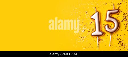 Number 15 gold celebration candle on a glitter background Stock Photo ...