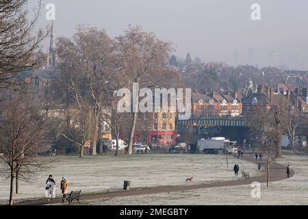 Park users walk through Brockwell Park on a cold January winter morning ...