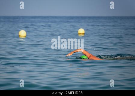 Swimmer floating crawl into the blue sea Stock Photo - Alamy