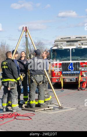 Firemen from various stations train to rescue a person stuck in a hole ...