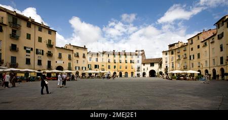 The famous round square Piazza dell Anfiteatro in the city of Lucca ...