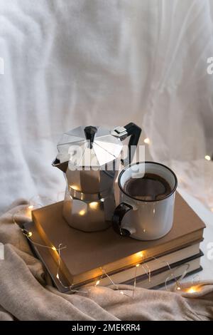 A moka pot end a cup of coffee in a cozy holiday environment. Enjoying ...