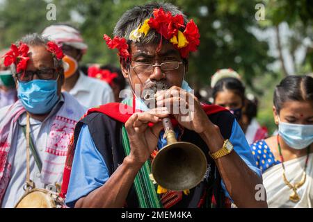 A Karbi tribal plays a traditional instrument during a religious ...